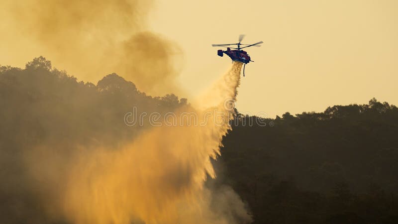 Fire Fighting Helicopter Dropping Water Onto Forest Fire Stock Photo ...