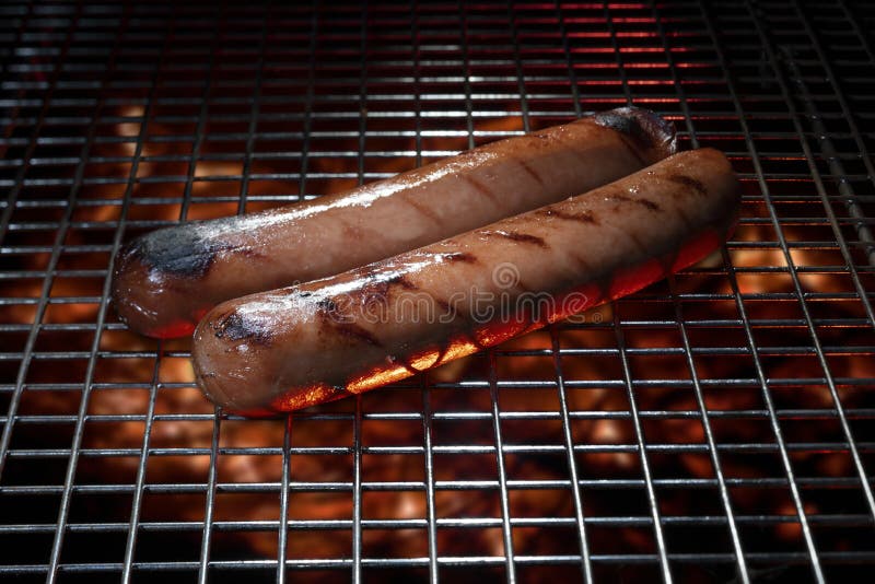 Fire Going Under a Pair of Hot Dogs on the Grill Stock Image - Image of ...
