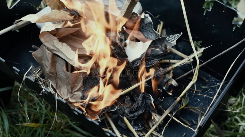 The Fire on the Grill Stands on the Grass. they Make Fire with Paper ...