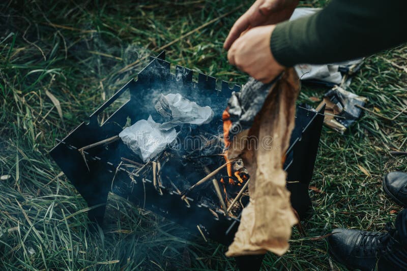 The Fire on the Grill Stands on the Grass. they Make Fire with Paper ...