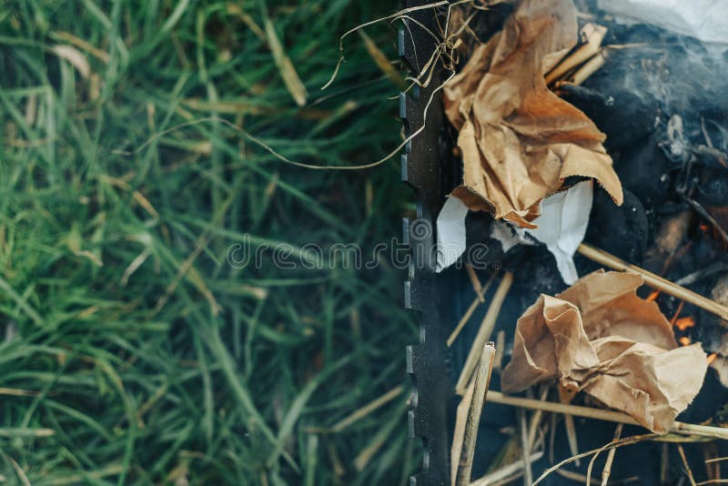 The Fire on the Grill Stands on the Grass. they Make Fire with Paper ...
