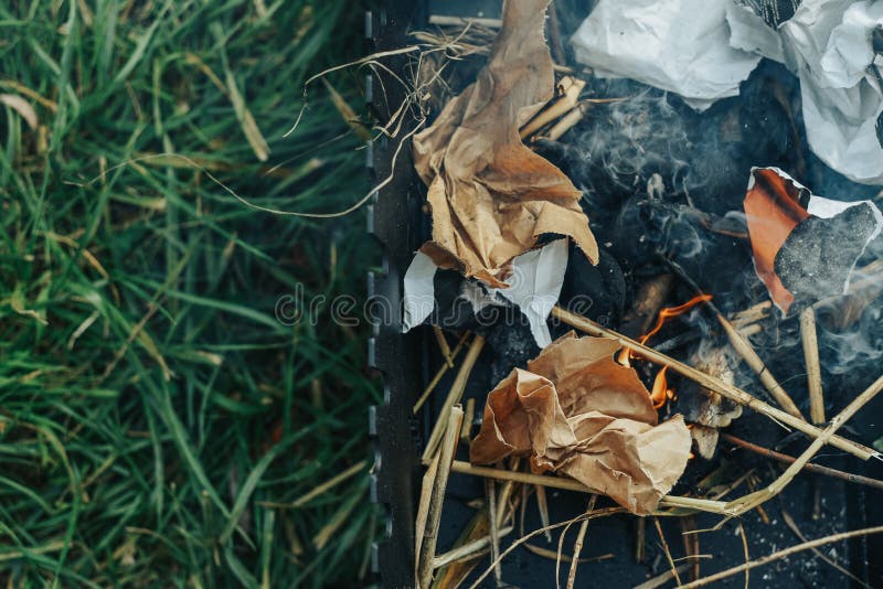 The Fire on the Grill Stands on the Grass. they Make Fire with Paper ...