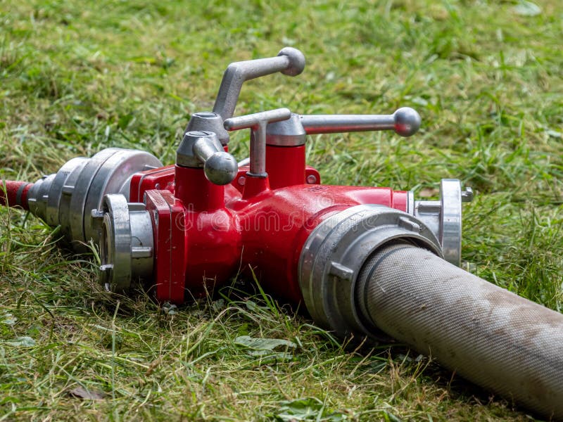 Fire Hose Distributor with Fire Hose on a Meadow Stock Photo - Image of ...