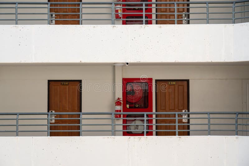 Fire Hose and Fire Extinguisher in a Hotel Corridor Stock Image - Image ...