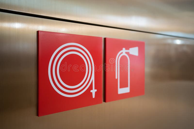 Fire Hose and Fire Extinguisher Signs on the Wall Stock Photo - Image ...