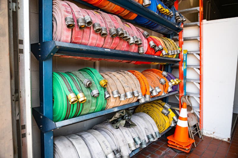 Fire Hoses of Different Colors are Stacked in Rows on a Fire Rack Stock ...