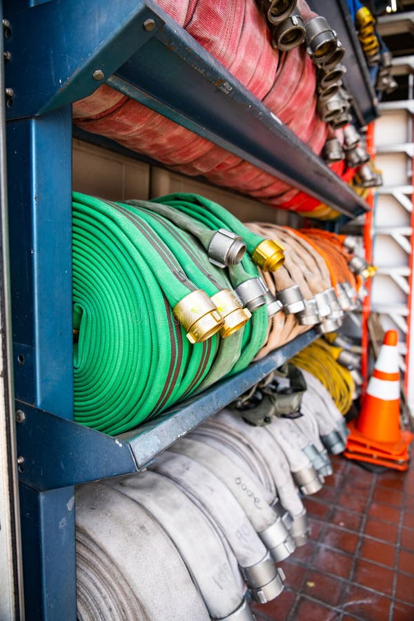 Fire Hoses of Different Colors are Stacked in Rows on a Fire Rack Stock ...