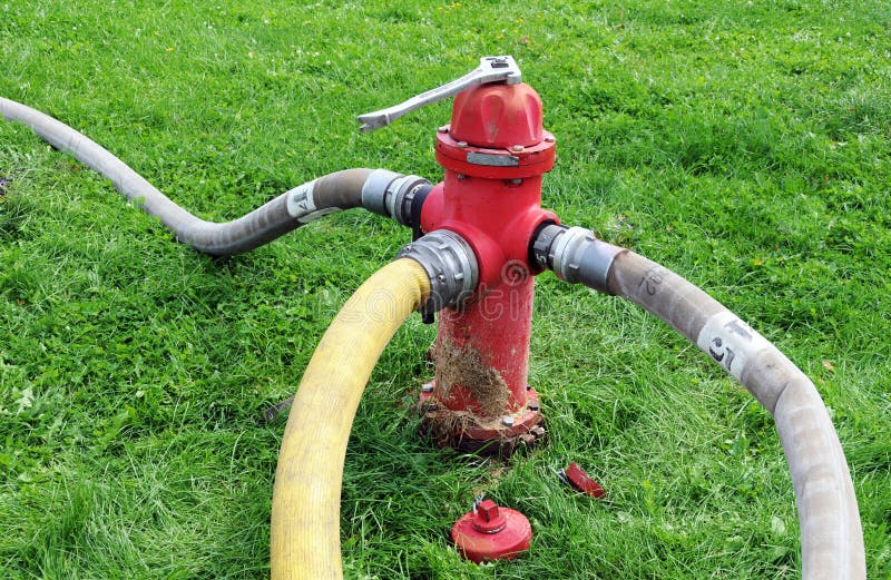 Red Fire Hydrant in Parking Lot with Safety Poles Stock Image - Image ...