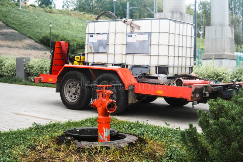 Fire Hydrant on the Background of a Trailer in Water Tanks for Watering ...