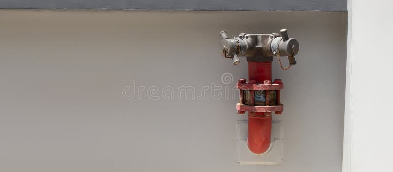 The Fire Hydrant is Installed on the Side of the Building Outside ...