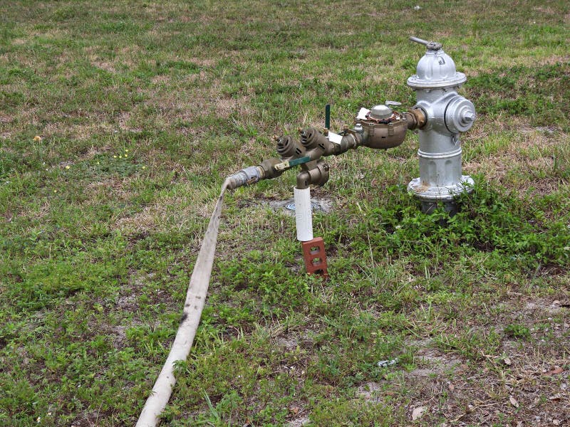 Fire Hydrant Painted Silver with Hose Attached Stock Image - Image of ...