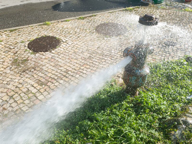 Fire Hydrant with Water Leak on Public Road, Lisbon. Stock Image ...