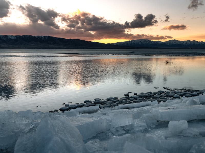 Fire and Ice. Ice Stacks in Foreground and Bright Orange Sunset Over ...