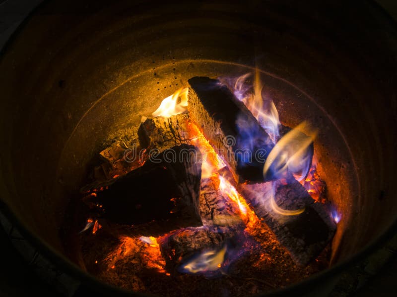 Fire in Iron Barrel on Tree Logs Stock Photo - Image of warm, heat ...
