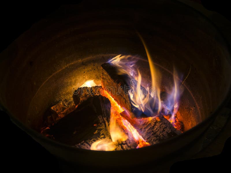 Fire in Iron Barrel on Tree Logs Stock Photo - Image of fire, logs ...
