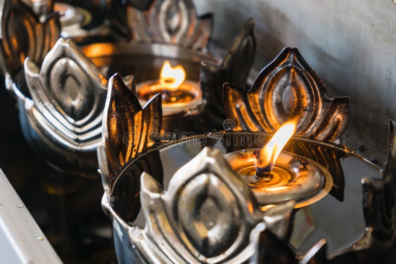 The Fire and the Large Oil Lamp Illuminate in Thai Temple Stock Image ...