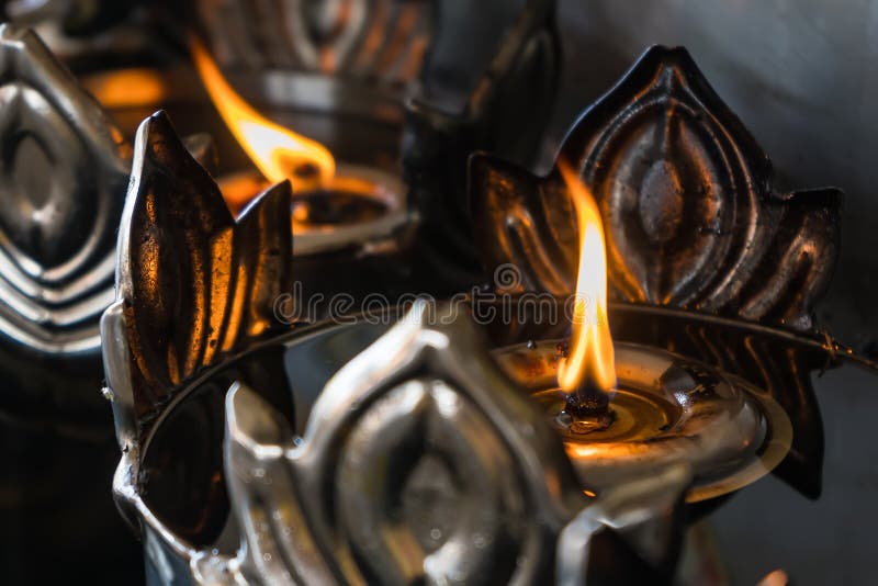 The Fire and the Large Oil Lamp Illuminate in Thai Temple Stock Photo ...