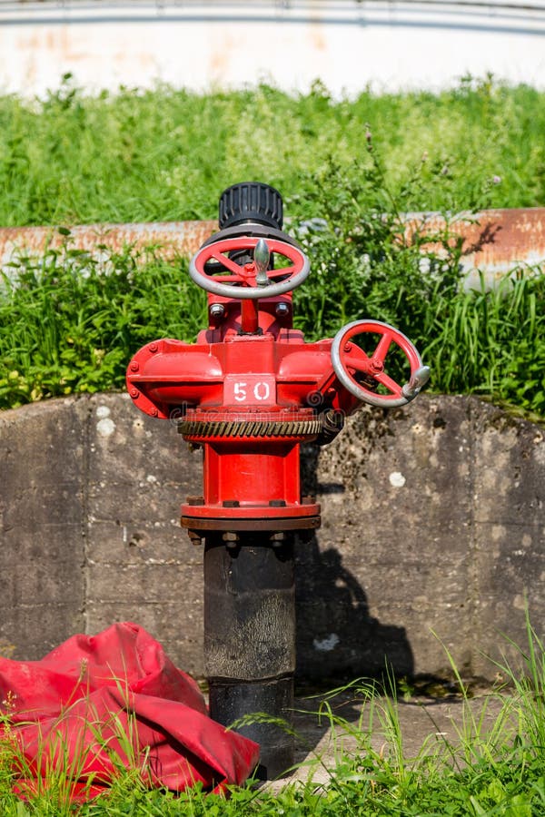 Closeup of a Red Fire Monitor in Front of a Storage Tank Stock Photo ...