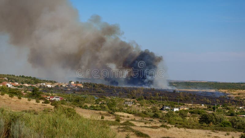 Fire near small village stock photo. Image of yellow - 100656826