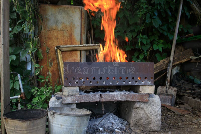 A Fire in an Old Brazier in a Dump of Things Stock Photo - Image of ...
