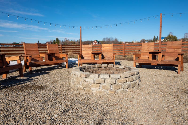 A Fire Pit with a String of Lights Hanging from the Top. Stock Photo ...