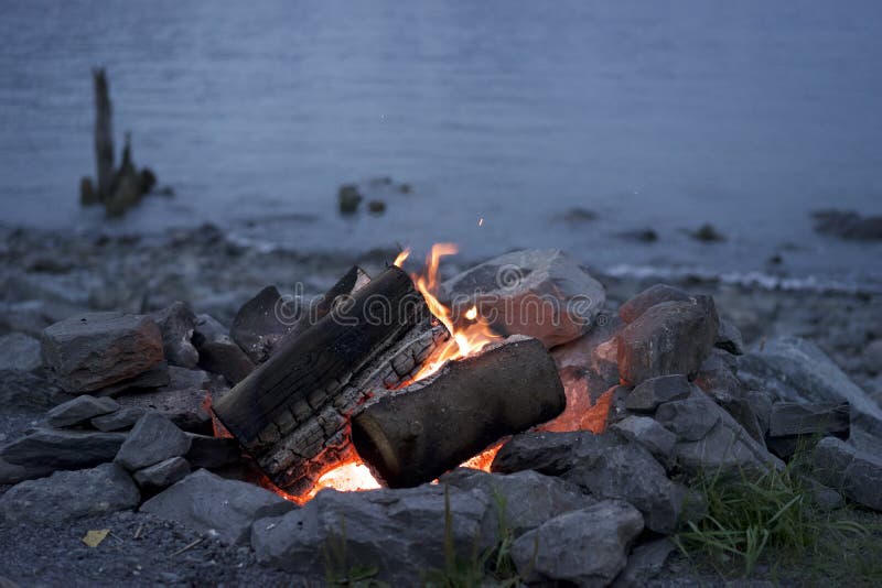 Fire Pit by the Water. stock photo. Image of happy, blue - 97859872