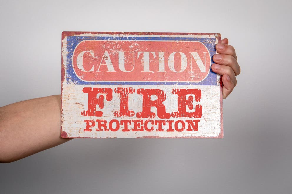 Fire Protection. Caution Sign with Text in Hand Stock Photo - Image of ...