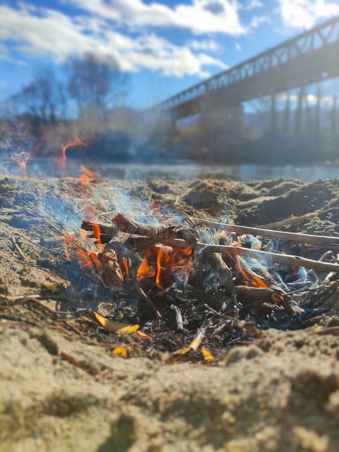Fire by the River on the Sand Stock Photo - Image of cloud, river ...
