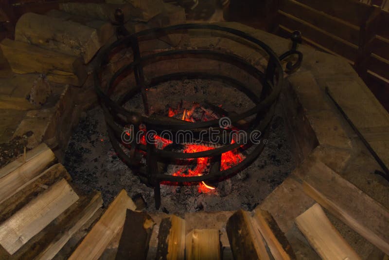 Fire in a Round Hearth and Wood Stock Photo - Image of indoors, board ...