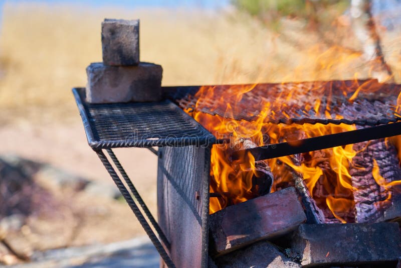 Fire in a Rusty Vintage Grill Outdoor on the Beach of the Sea Stock ...
