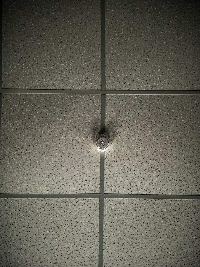 A Fire Safety Device, Likely a Smoke Detector, is Centered among the ...