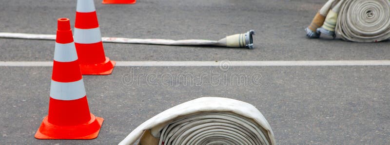 Fire Safety Drill Setup with Fire Hoses and Traffic Cones Arranged on ...