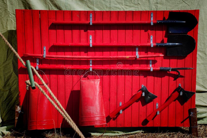 Red Fire Shield with Tools and Buckets Stock Photo - Image of clothing ...
