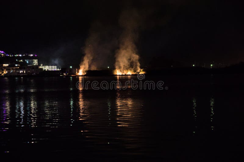 Fire on the Shore of the Lake, Burning a Lot of Vegetation. Stock Photo ...