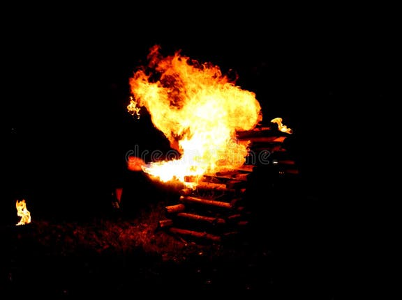 Fire Show.the Man is Spitting Fire and Ignites the Bonfire. Stock Image ...