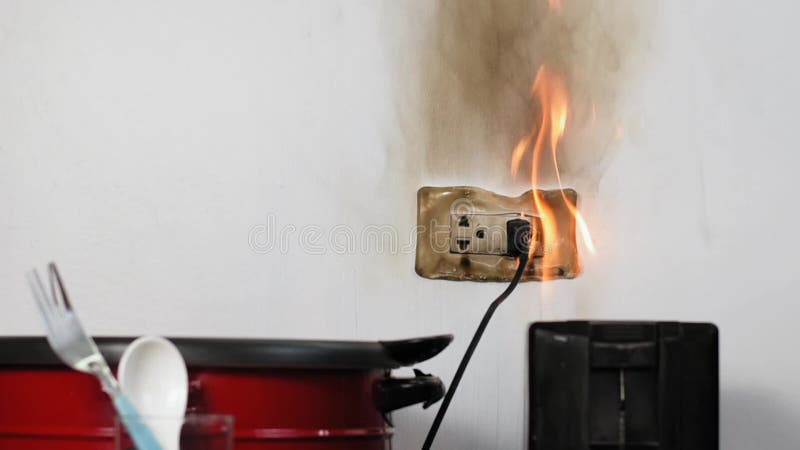 Fire from Plugging Power Cable into Overloaded Electric Outlet Stock ...