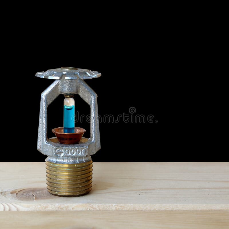 Fire Sprinkler with Fire on Wooden Background. Stock Photo - Image of ...