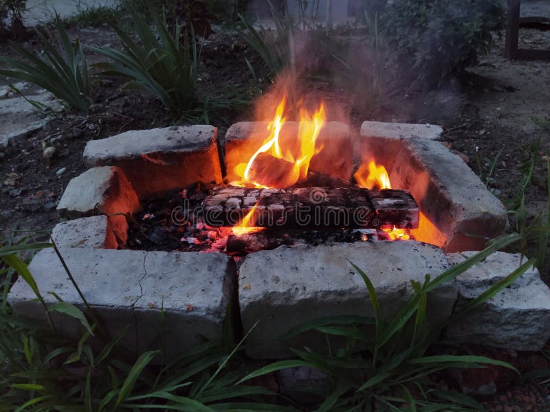 Fire Pit and Stone Benches Against Building with Stone Brick Wall and ...