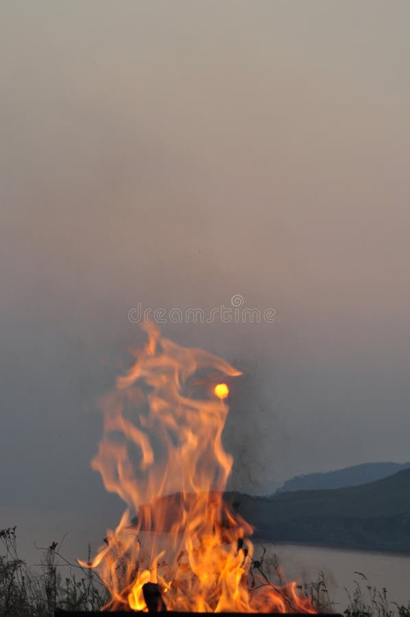 Fire and Sun with Smoke and View on the River and Hill Stock Image ...