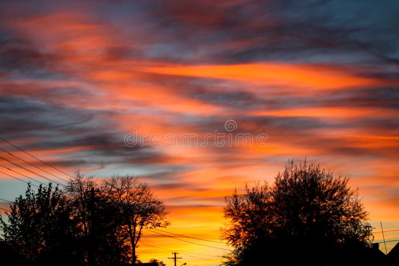 Fire Sunset with Hazy Clouds and Backlit Tree Stock Image - Image of ...