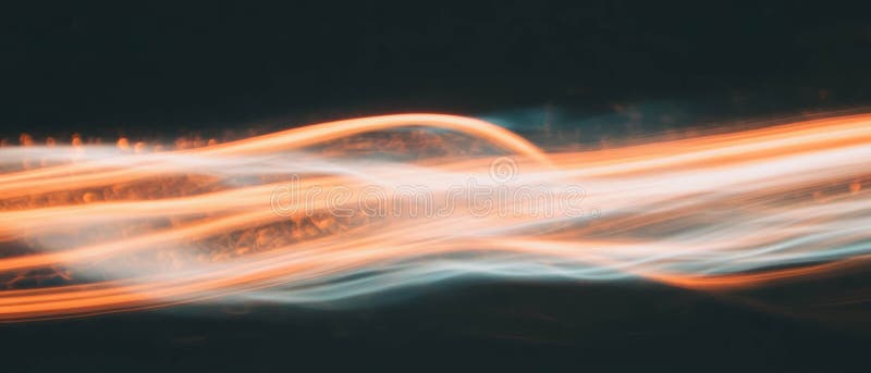 Fire Trails Create Smooth Light Patterns on a Dark Background with a ...
