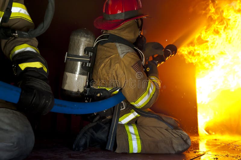 Fireman at a House Fire stock image. Image of hose, roof - 15150963