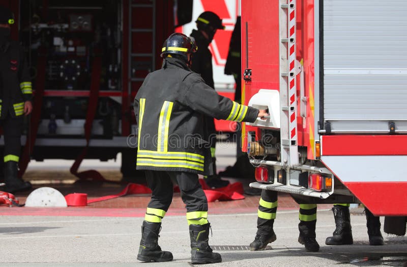 Fire Truck during Firefighter Intervention with Firefighters in Uniform ...