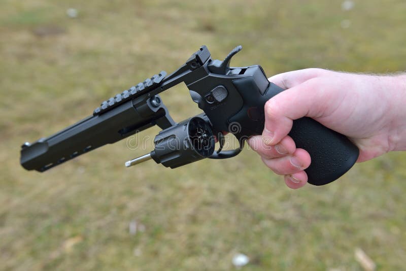 Firearms and Security Topic: Hand Man with a Gun Ready To Put Bu Stock ...