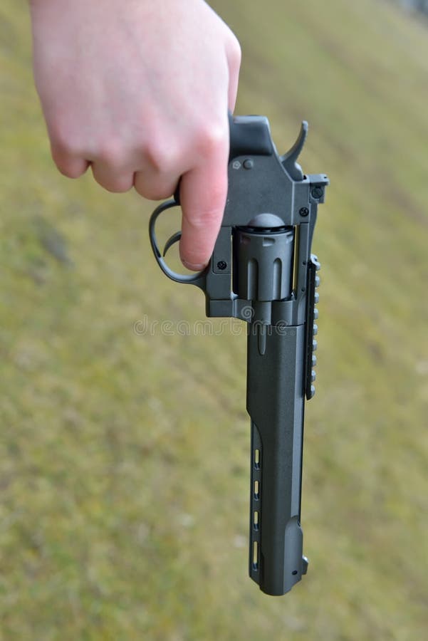 Firearms and Security Topic: Hand Man with a Gun Ready To Shoot Stock ...