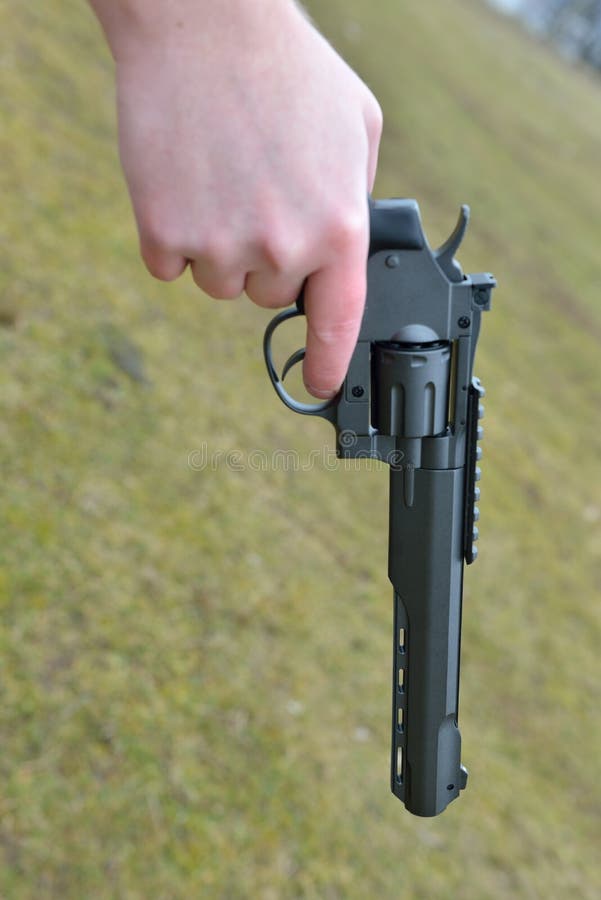 Firearms and Security Topic: Hand Man with a Gun Ready To Shoot Stock ...