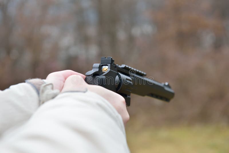 Firearms and Security Topic: Hands Man with a Gun Ready To Shoot Stock ...