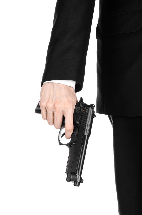 Firearms and Security Topic: a Man in a Black Suit Holding a Gun on an ...