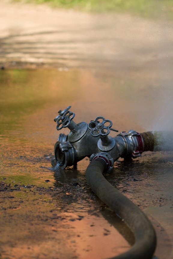 Firecock with Leaking Firehose Stock Image - Image of break, rupture ...