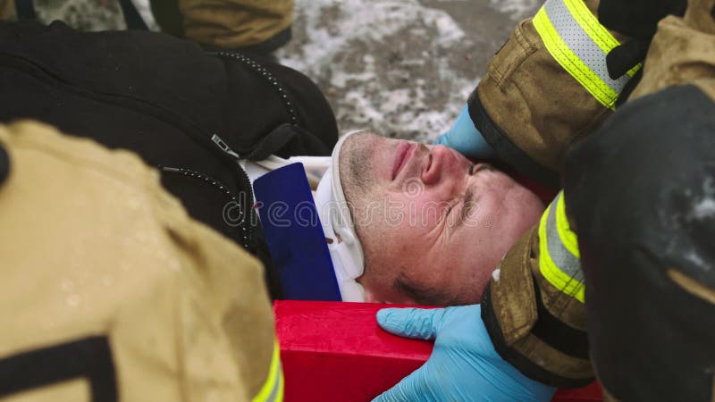 Firefghters Lifting Injured Man. Rescue after Car Crash Accident Stock ... Firefghters Lifting Injured Man. Rescue after Car Crash Accident Stock ...